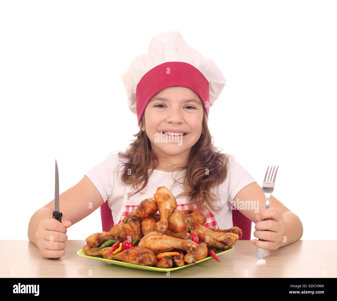 little girl cook with chicken drumstick on plate ready for lunch Stock ...