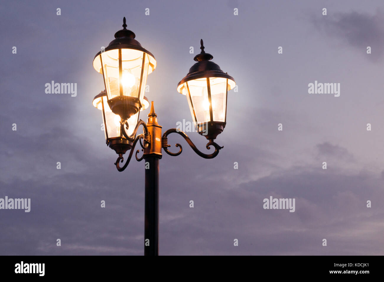 Old fashioned street lights shot against a cloudy sky Stock Photo - Alamy