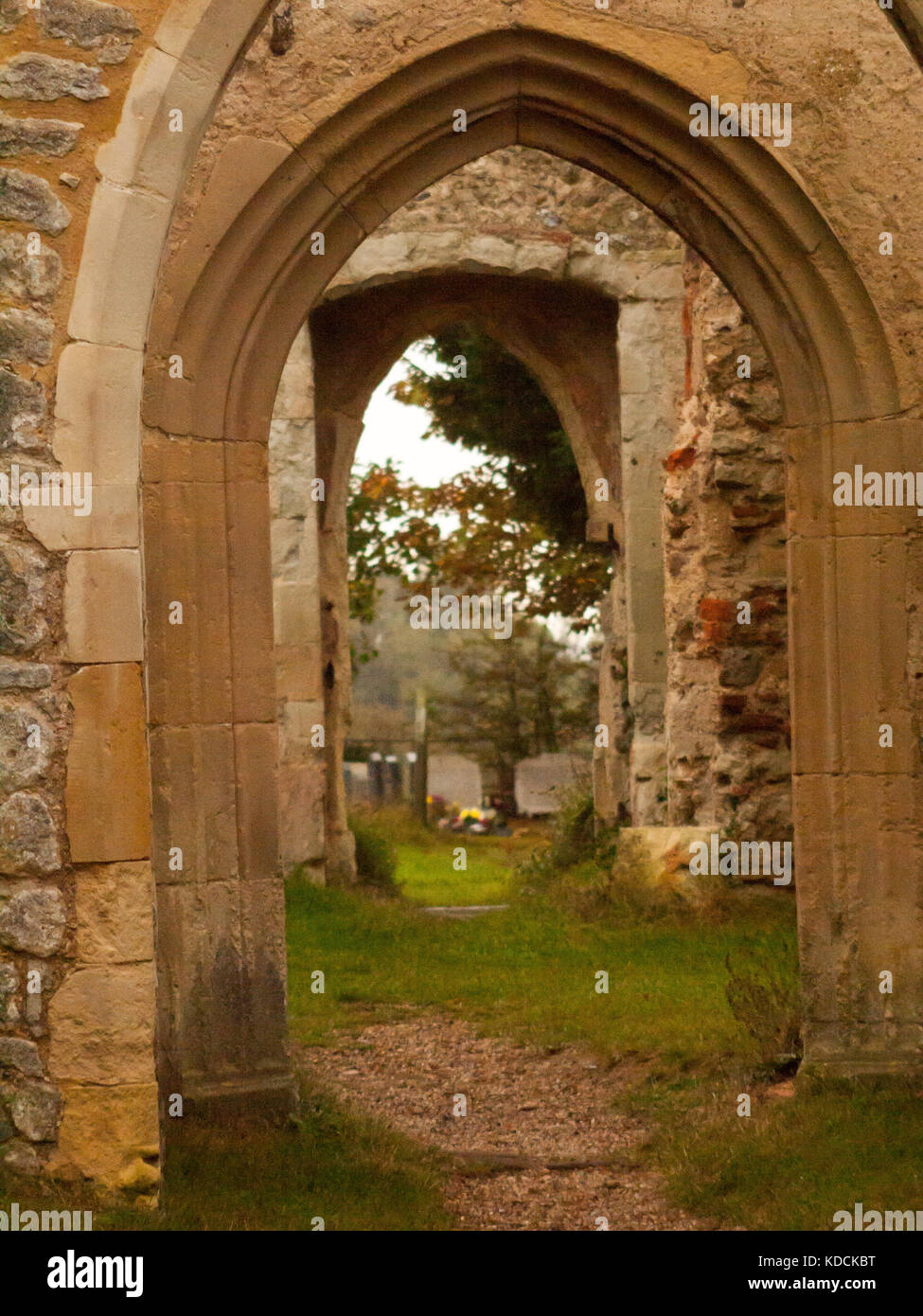 zoom in through stone arch ways of abandoned burnt down church; essex ...