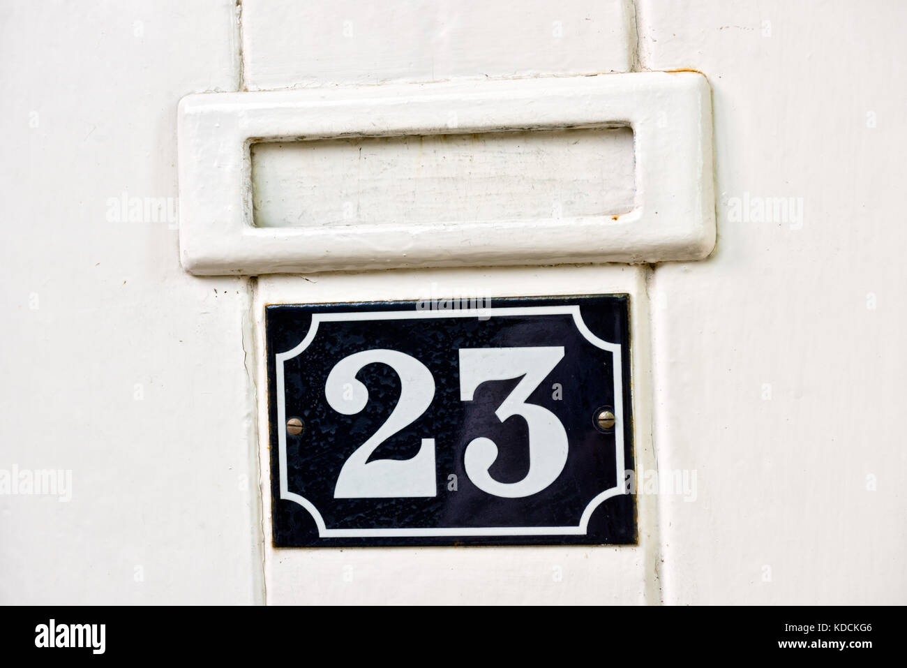The number 23 under a letterbox on a front door. Signifying the address ...