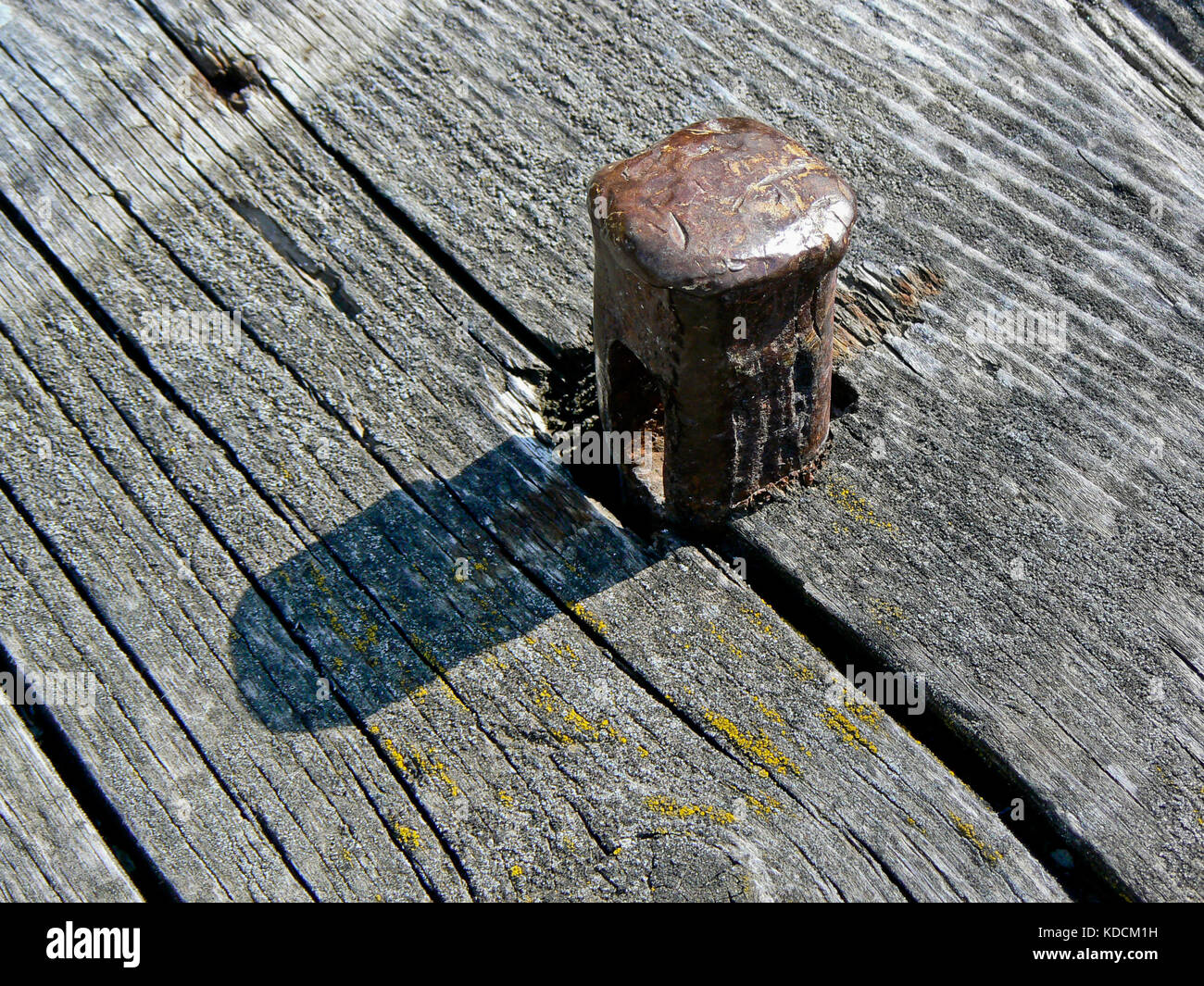 A stud protruding from the wood of a bench Stock Photo - Alamy