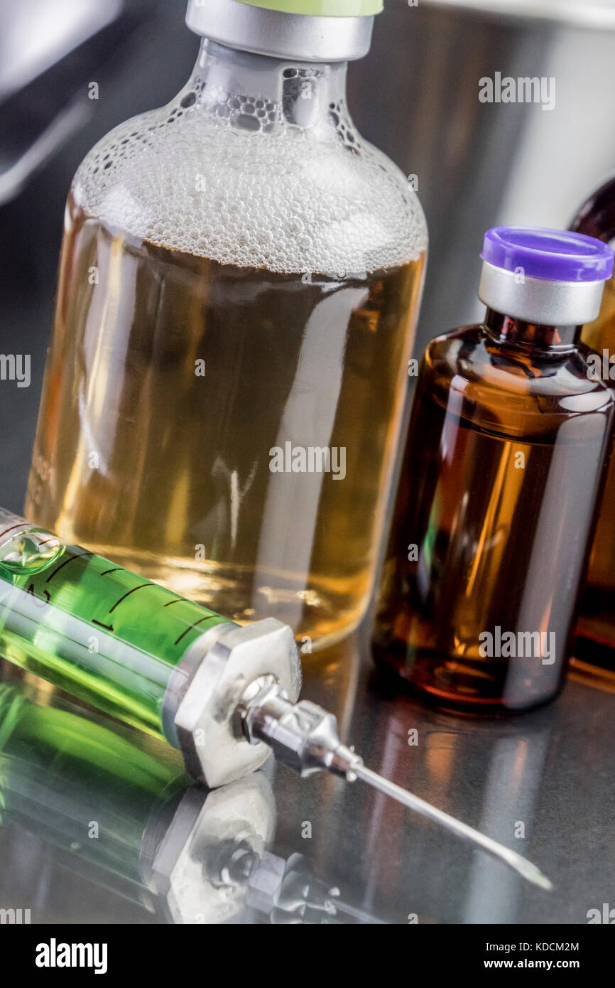 Several vials and syringe in laboratory, conceptual image Stock Photo - Alamy