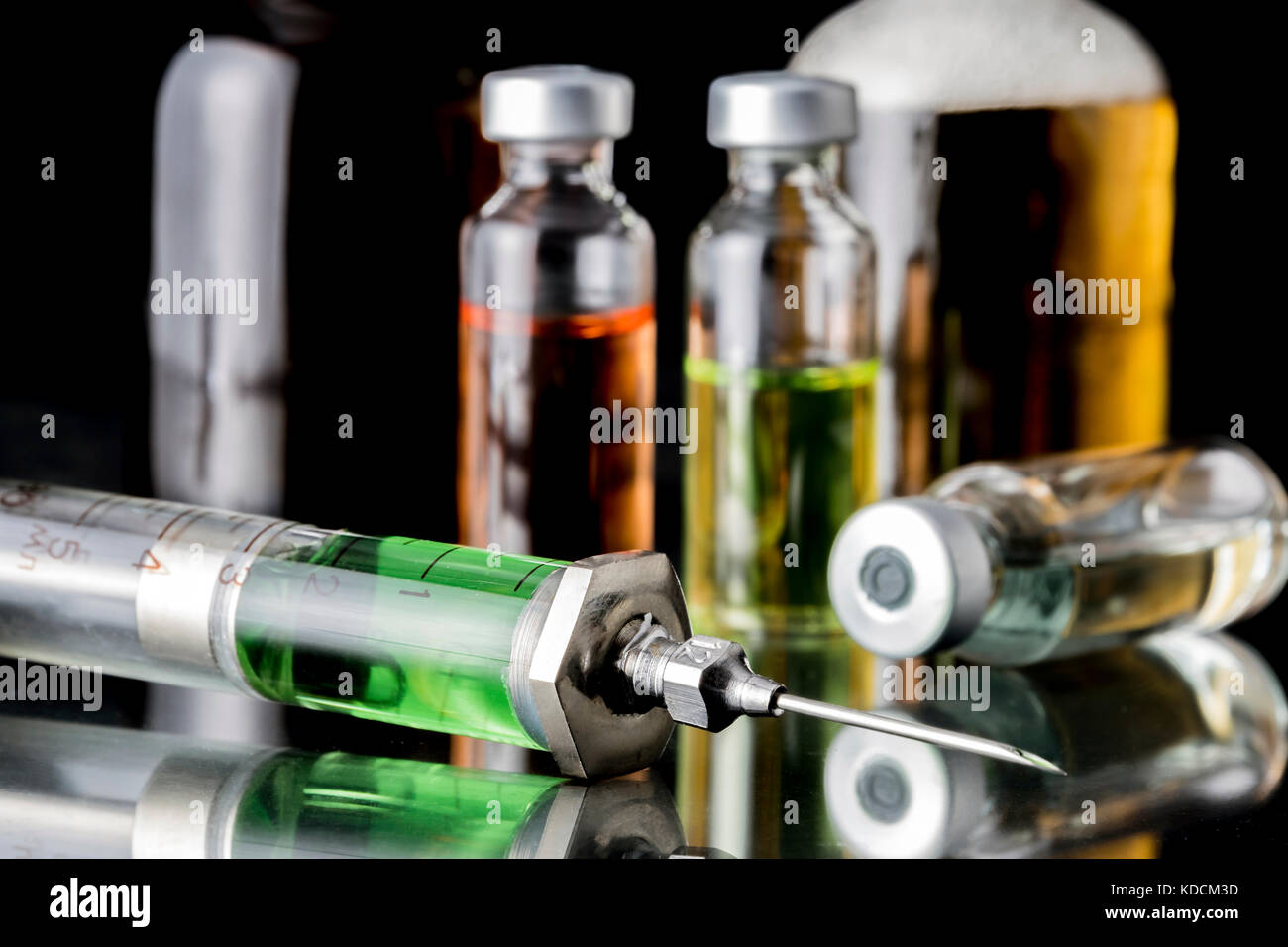 Several vials and syringe in laboratory, conceptual image Stock Photo - Alamy