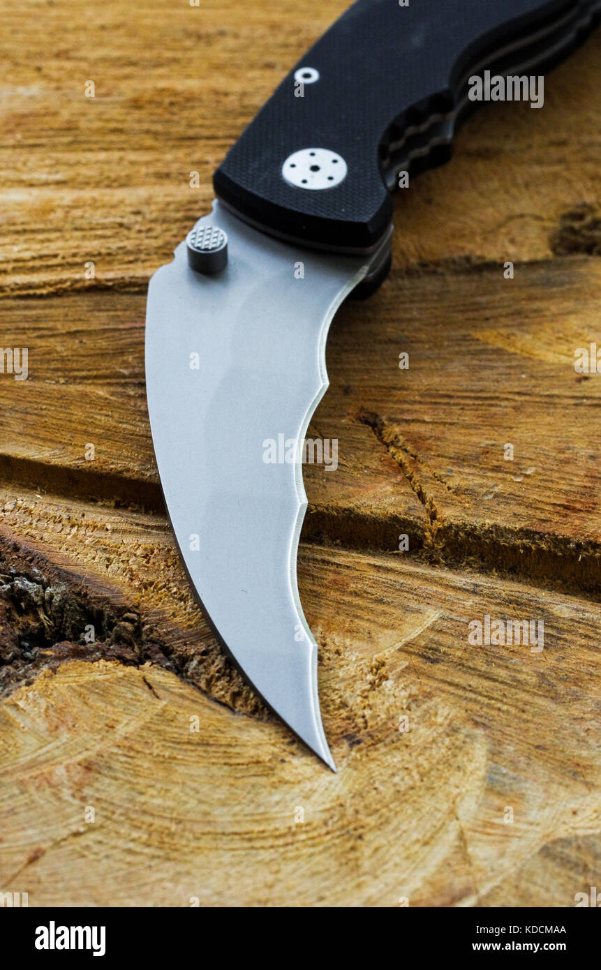 The knife blade is undulating. Knife as a claw of a tiger. Vertical ...