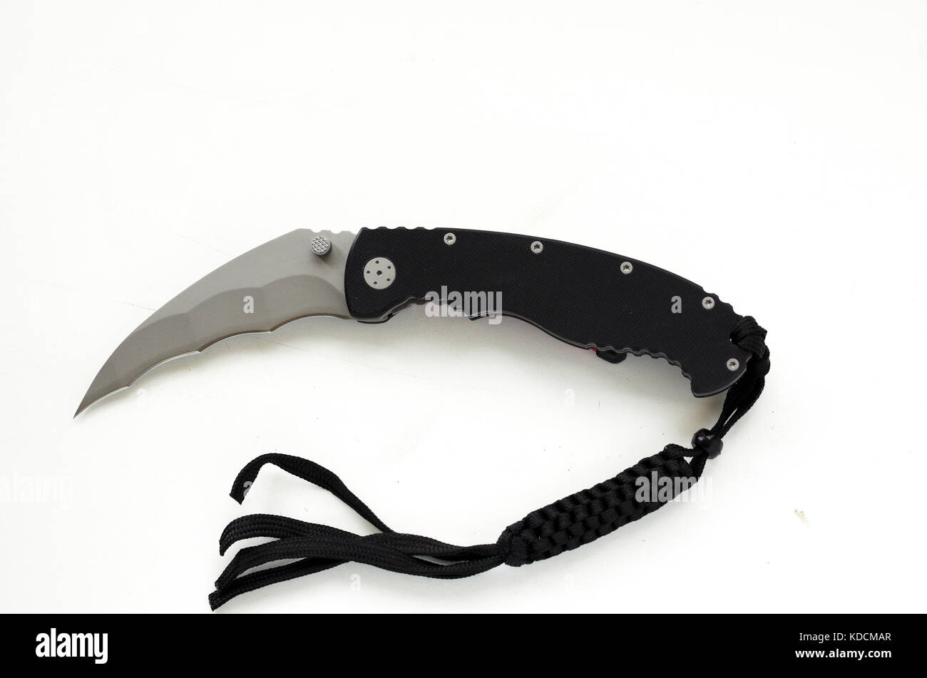 A pocket knife with a curved blade on a white background. Claw of a ...