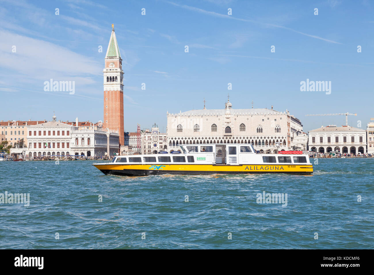 Yellow Alilaguna ferry passing the Campanile and Doges Palace, San ...