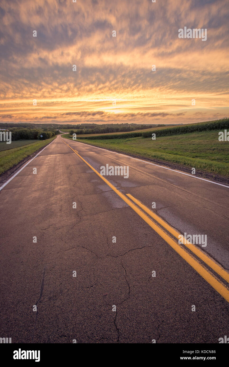 The sun sets over a road in the rural Minnesota countryside Stock Photo ...
