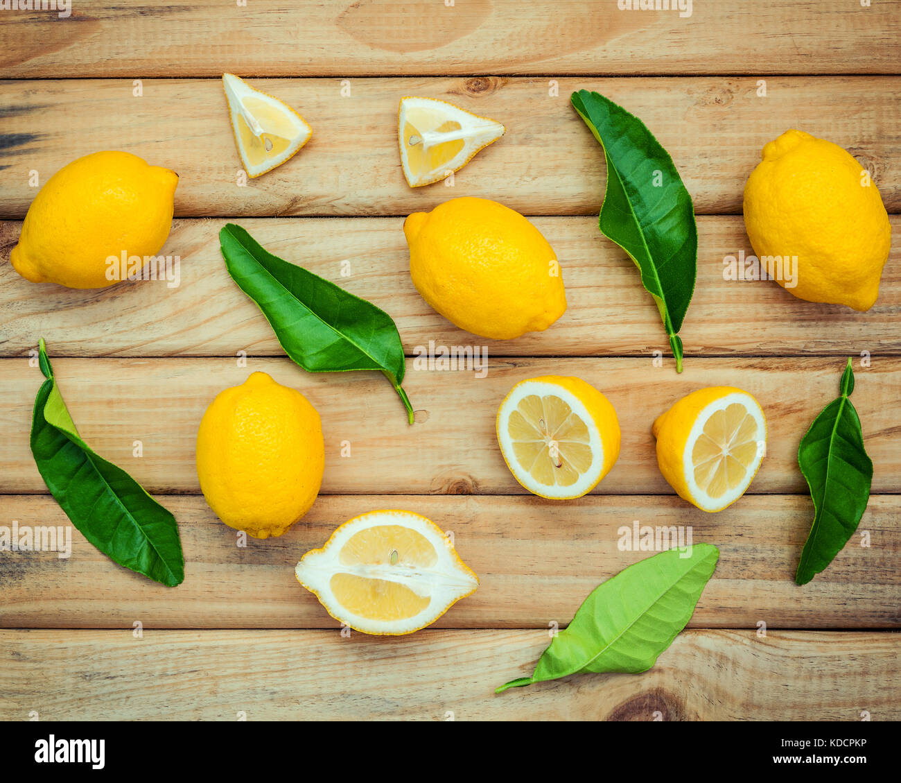 Fresh lemons and lemons leaves on rustic wooden background. Fresh ...