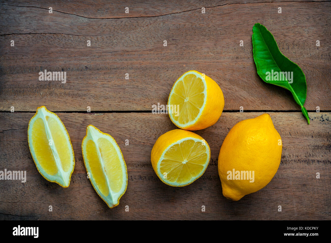 Fresh lemons and lemons leaves on rustic wooden background. Fresh ...