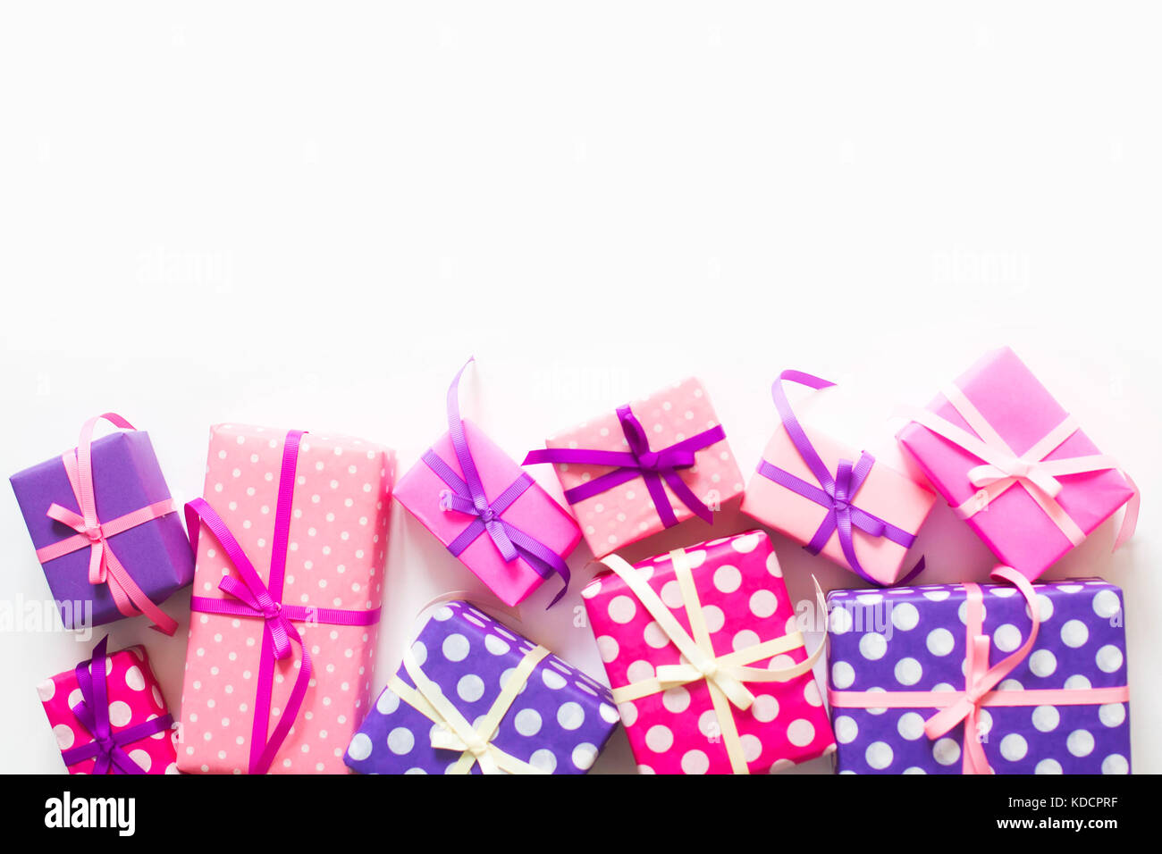 Colored gift boxes with colorful ribbons. white background. Gifts for ...