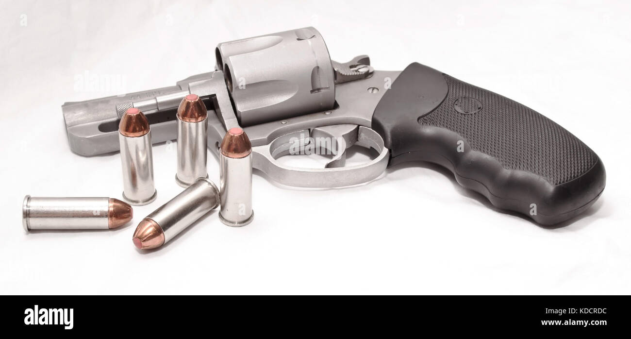 An unloaded 44spl revolver with the cylinder opened and it's bullets ...