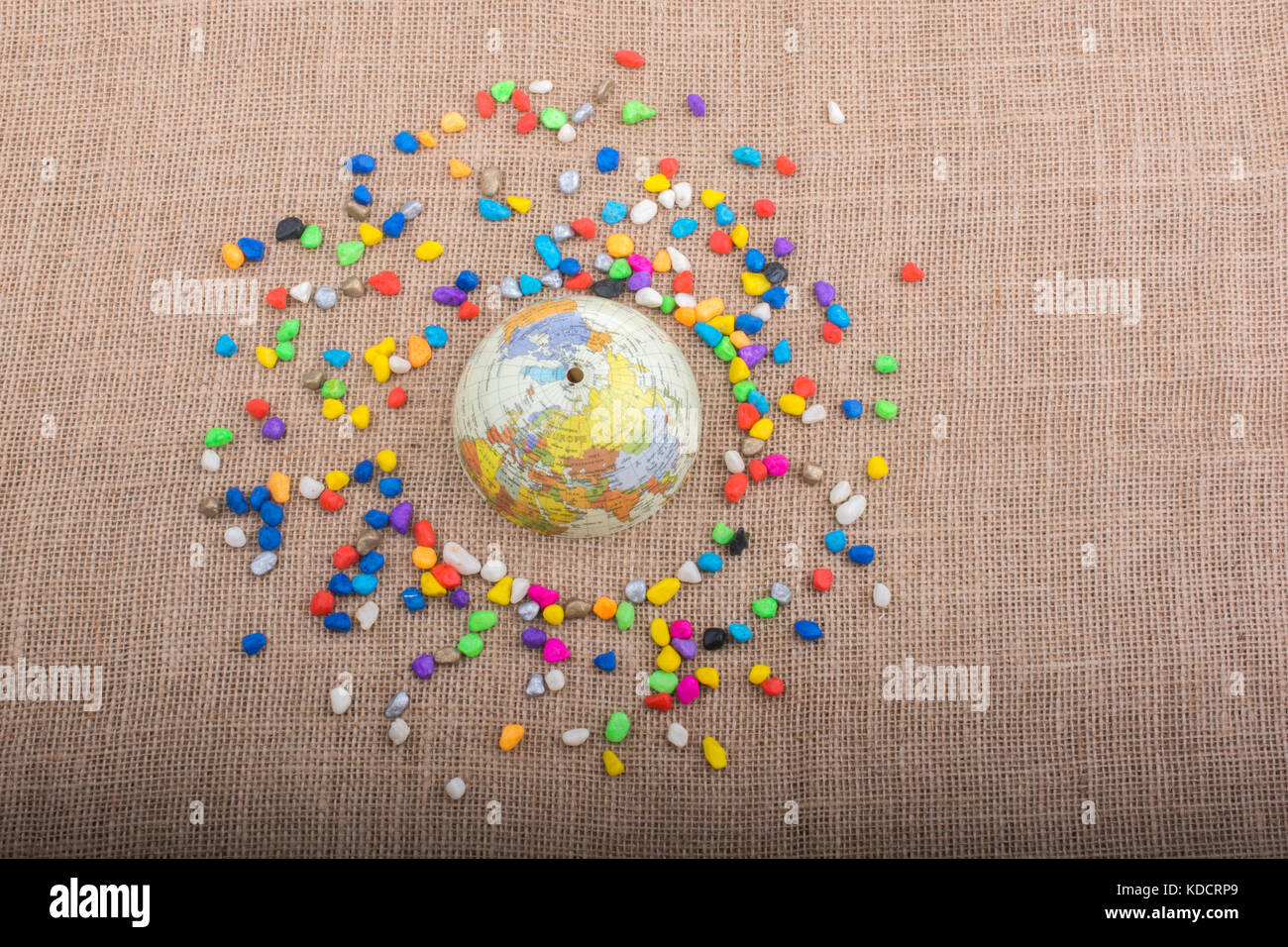 Model globe placed amid colorful pebbles Stock Photo - Alamy
