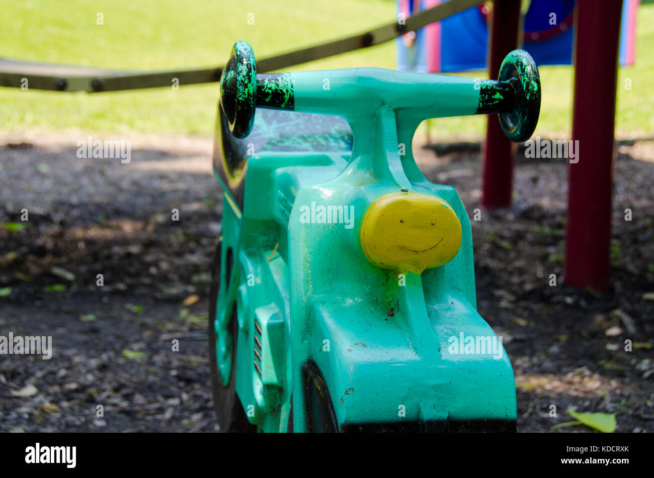 Green motorcycle toy on a playground Stock Photo - Alamy