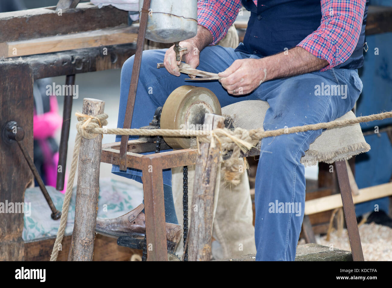 Asti, Italy - September 10, 2017: blacksmith sharpens the hatchet with ...