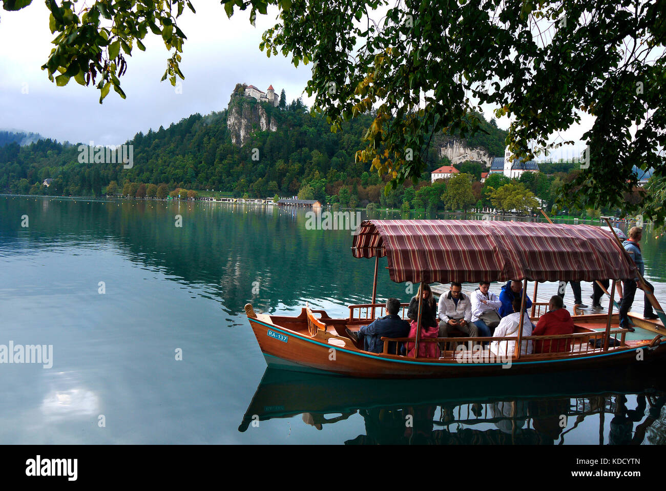 Tourists prepare for a pleasure boat trip round Lake Bled in Bled ...