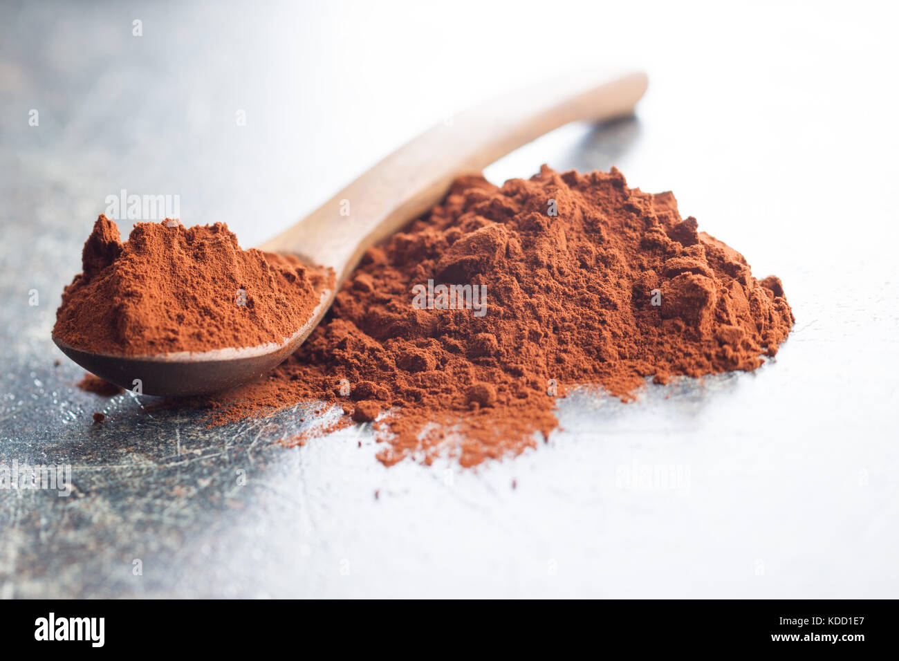 Dark cocoa powder in wooden scoop on old kitchen table Stock Photo - Alamy