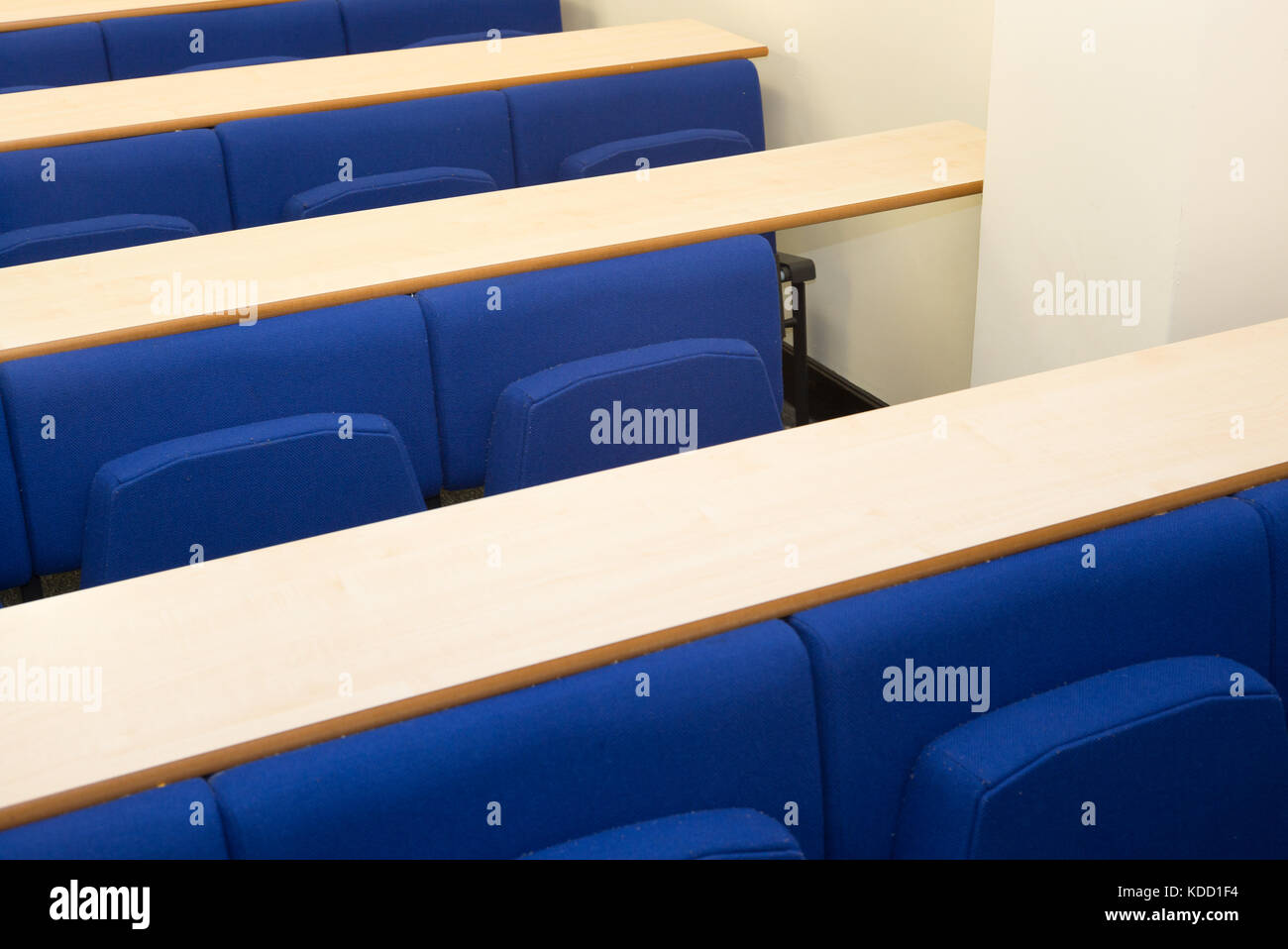Empty rows of seats and table in university classroom, Cardiff, Wales ...