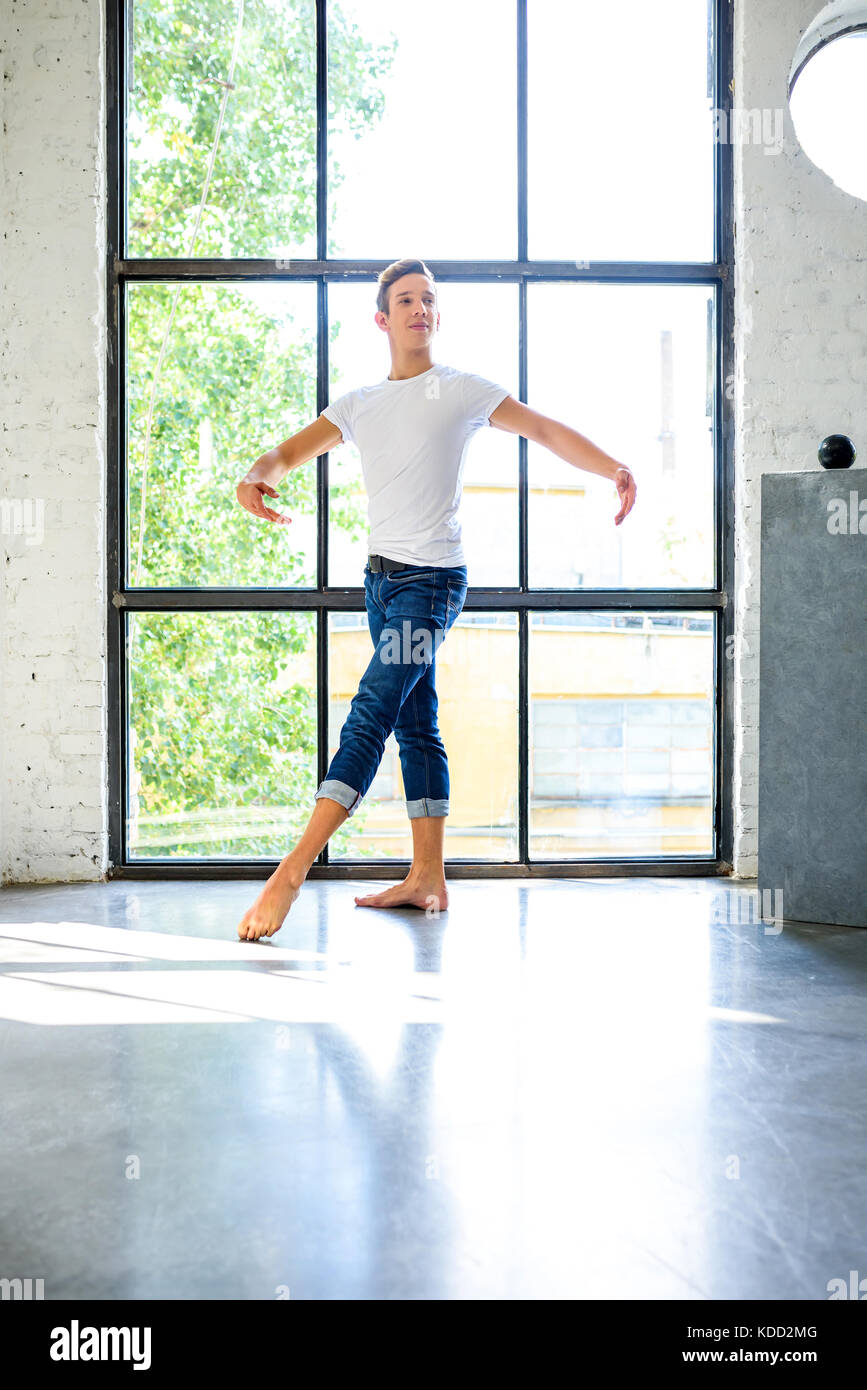 A handsome young male Ballet dancer practicing in a Loft style ...