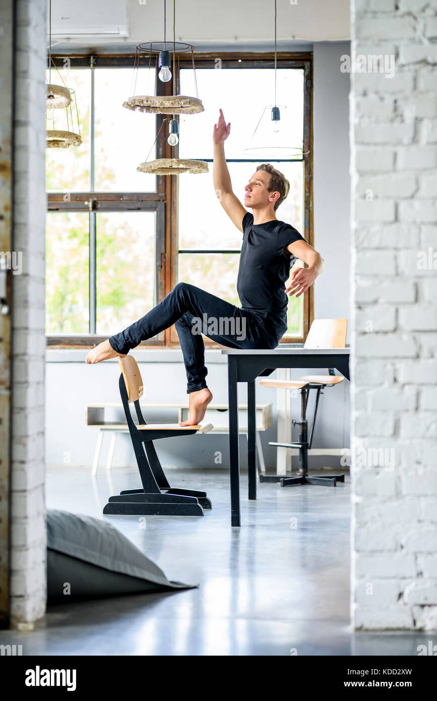 A young handsome Dancer relaxing in a loft style apartment Stock Photo ...