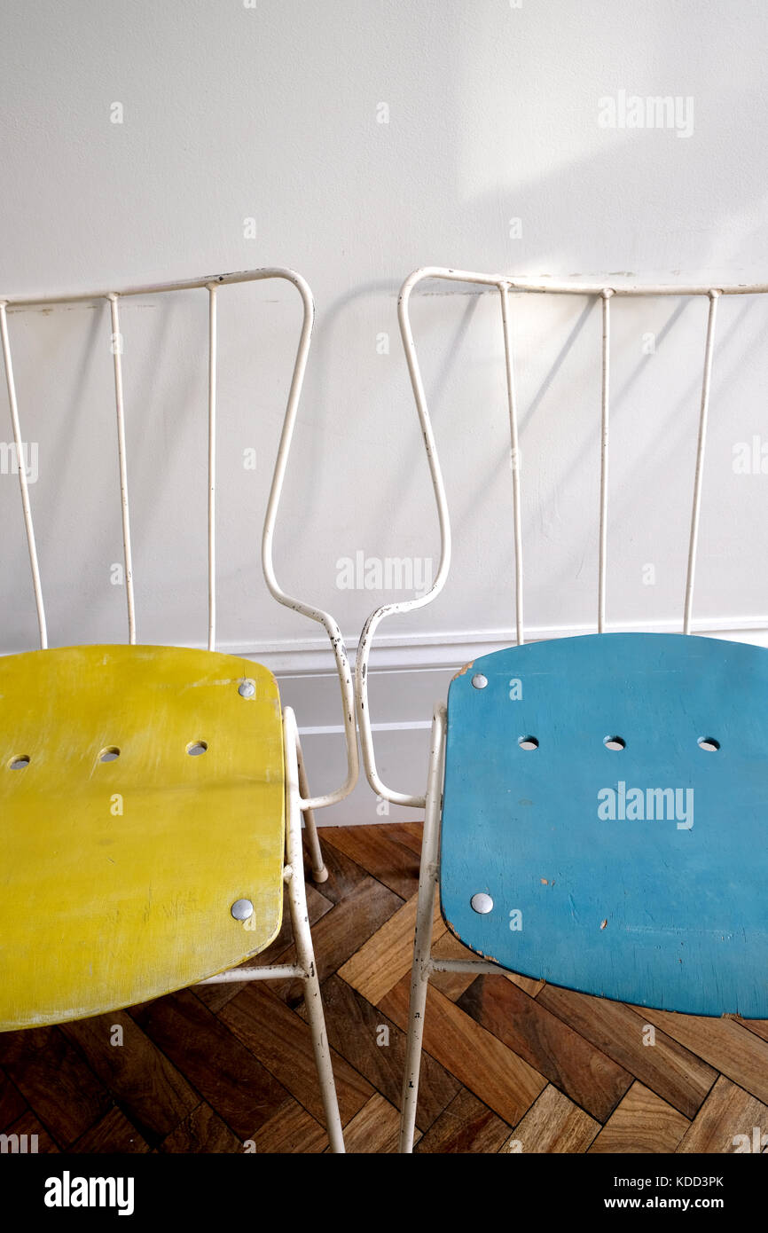 Two vintage chairs with colourful seats Stock Photo - Alamy