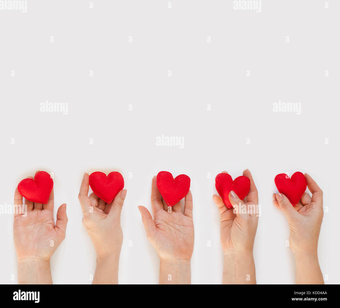Many hands holding the heart. White background Stock Photo - Alamy