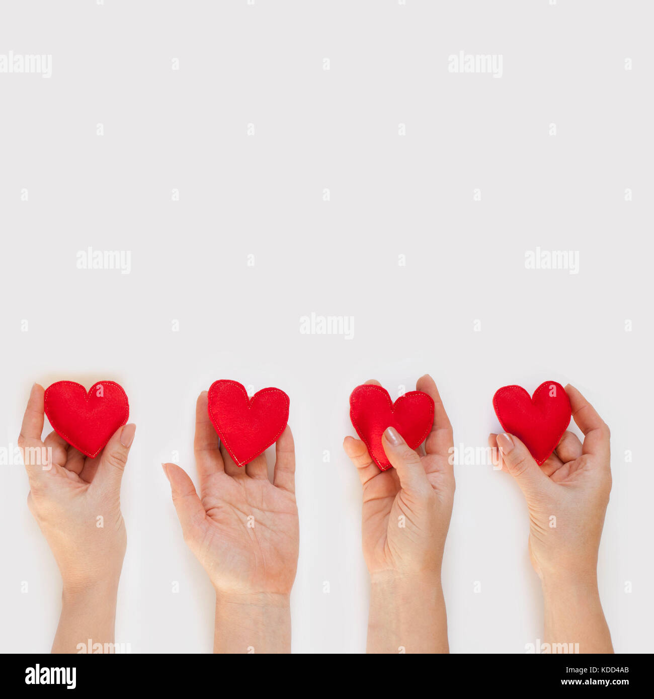 Many hands holding the heart. White background Stock Photo - Alamy