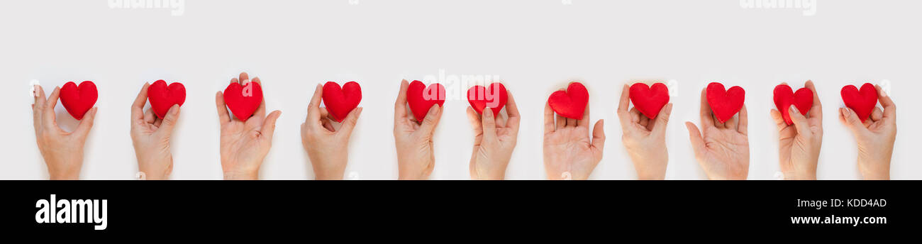Many hands holding the heart. White background Stock Photo - Alamy