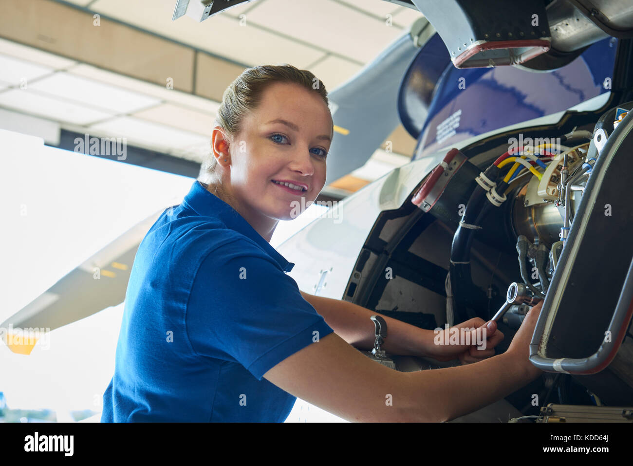 Portrait Of Female Aero Engineer Working On Helicopter In Hangar Stock ...