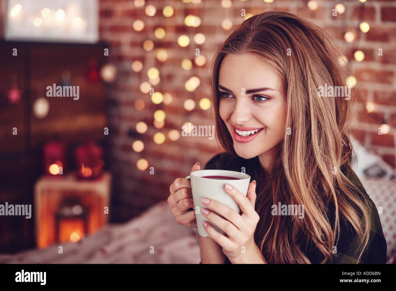 Attractive woman drinking hot tea Stock Photo - Alamy
