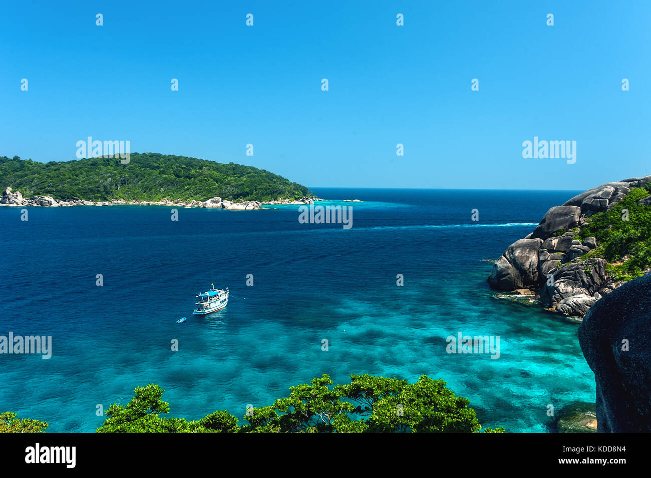 Beautiful view of the Bay with clear water and a boat with mountains in ...