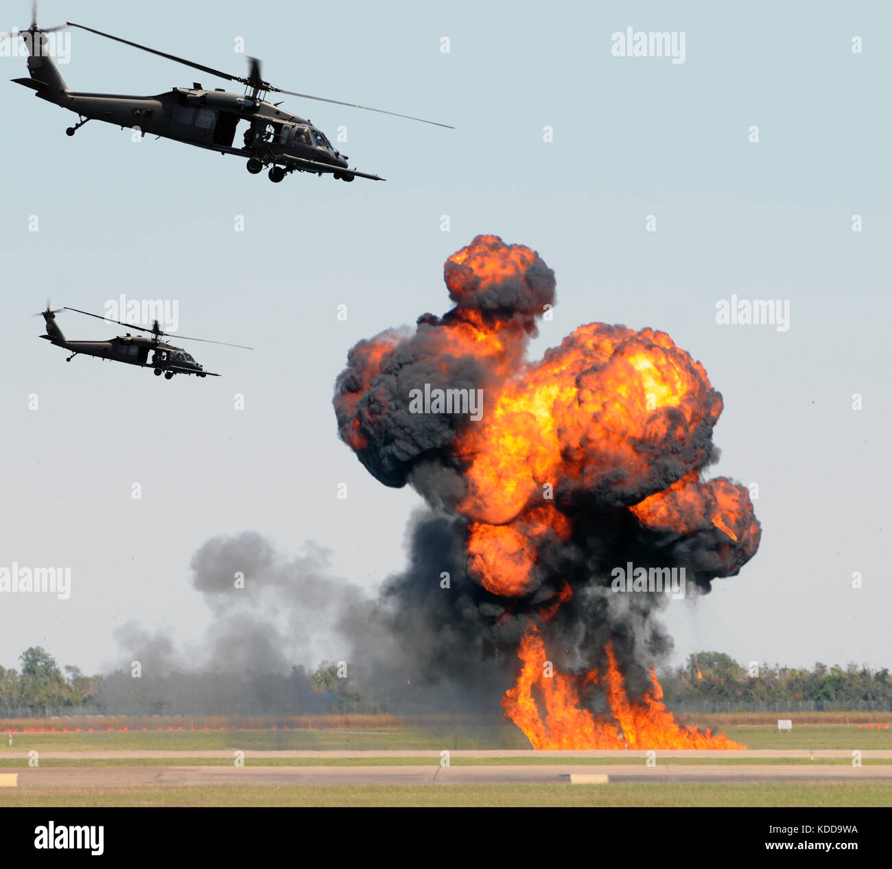 Helicopters mounting a ground attack with explosions and smoke Stock ...