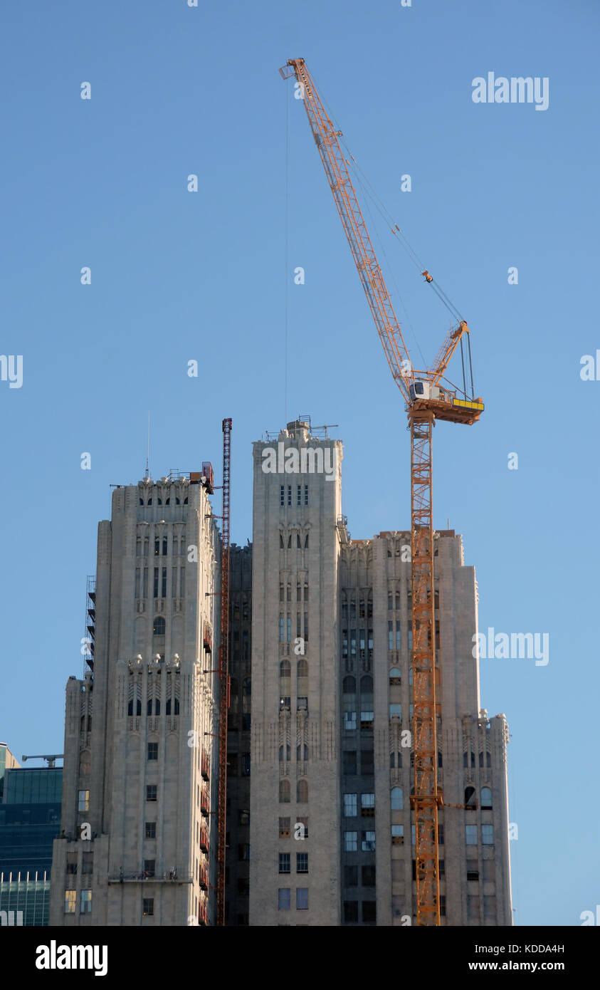 Tall crane constructing skyscraper Stock Photo - Alamy