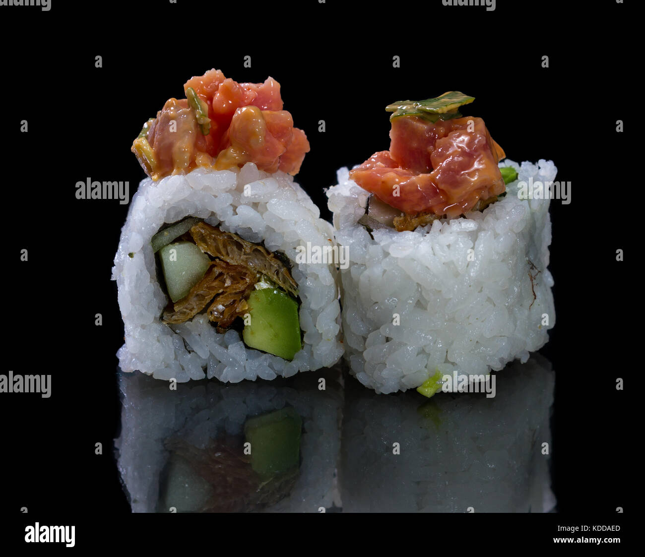 close up of a couple of pieces of sushi wrapped with rice and topped ...