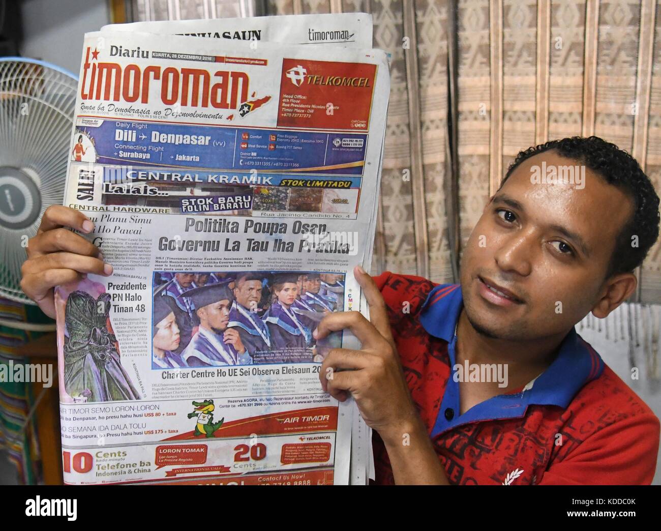 Journalist holding daily newspaper, Dili (Timor Leste), Dec. 28, 2016 ...