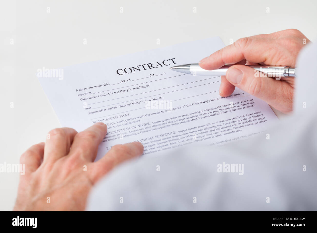 Close-up Of A Businessman Reading Contract Paper Stock Photo - Alamy