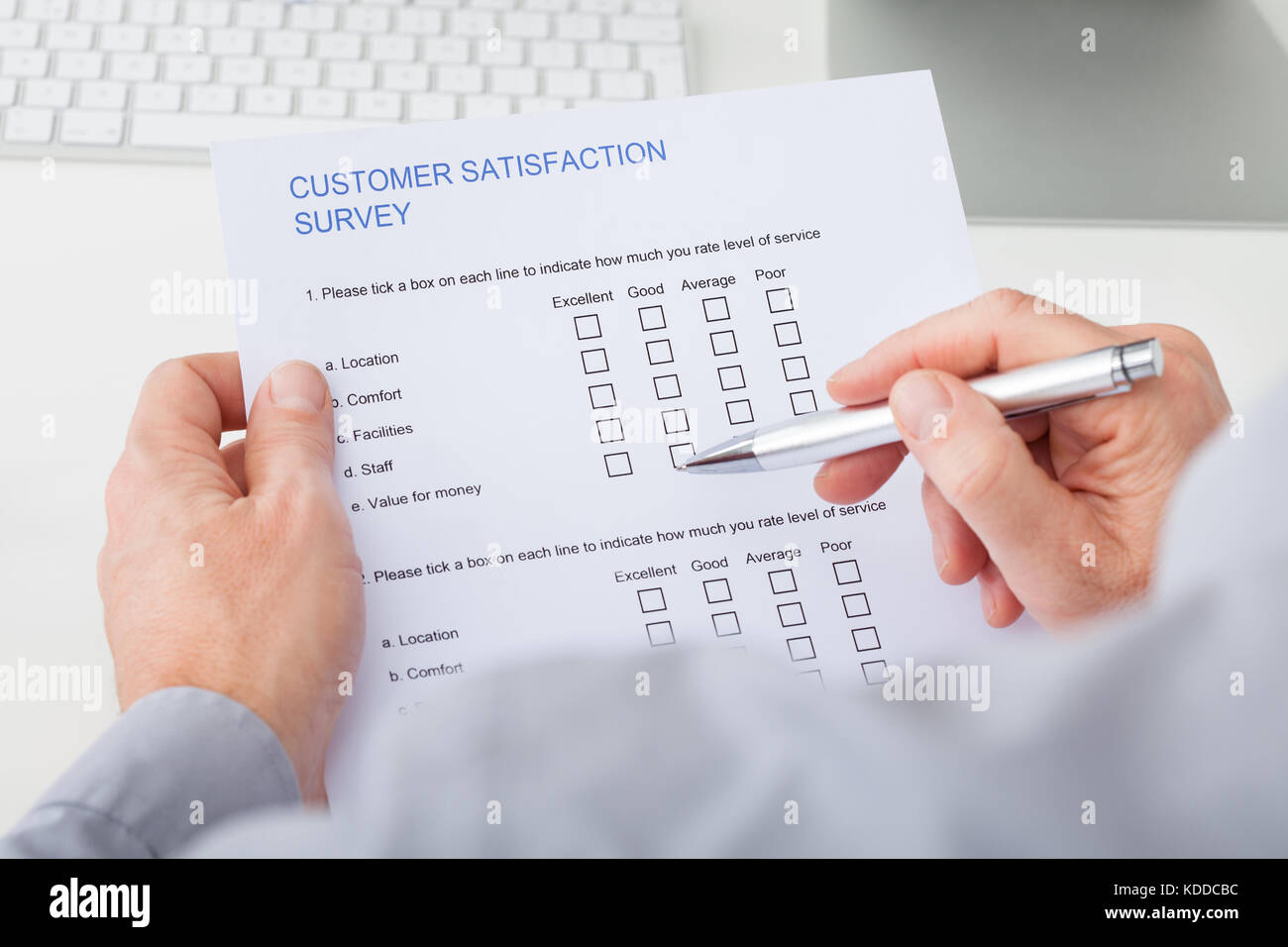Close-up Of Man's Hand Filling Customer Survey Form Stock Photo - Alamy