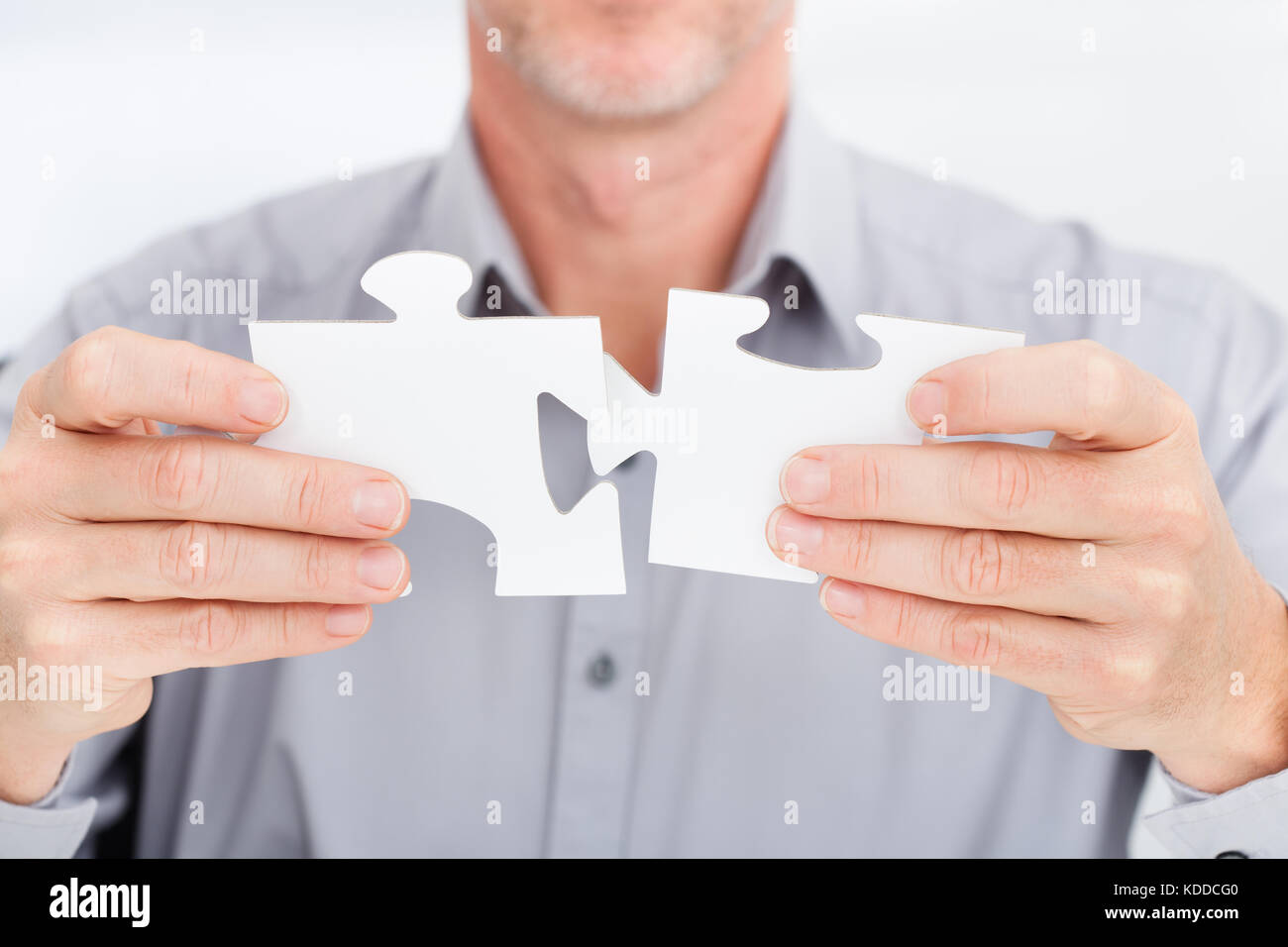 Close-up Of A Mature Businessman Solving Jigsaw Puzzle In Office Stock ...