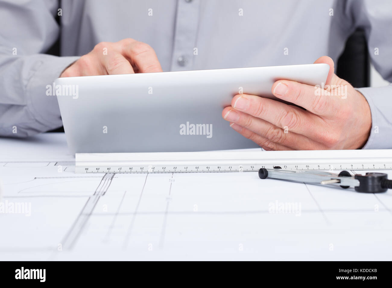Close-up Of Architect Using Digital Tablet Over Blueprint Stock Photo ... Close-up Of Architect Using Digital Tablet Over Blueprint Stock Photo ...