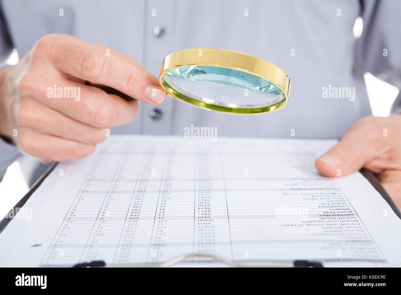 Businessman Looking At Document Through Magnifying Glass On White ...