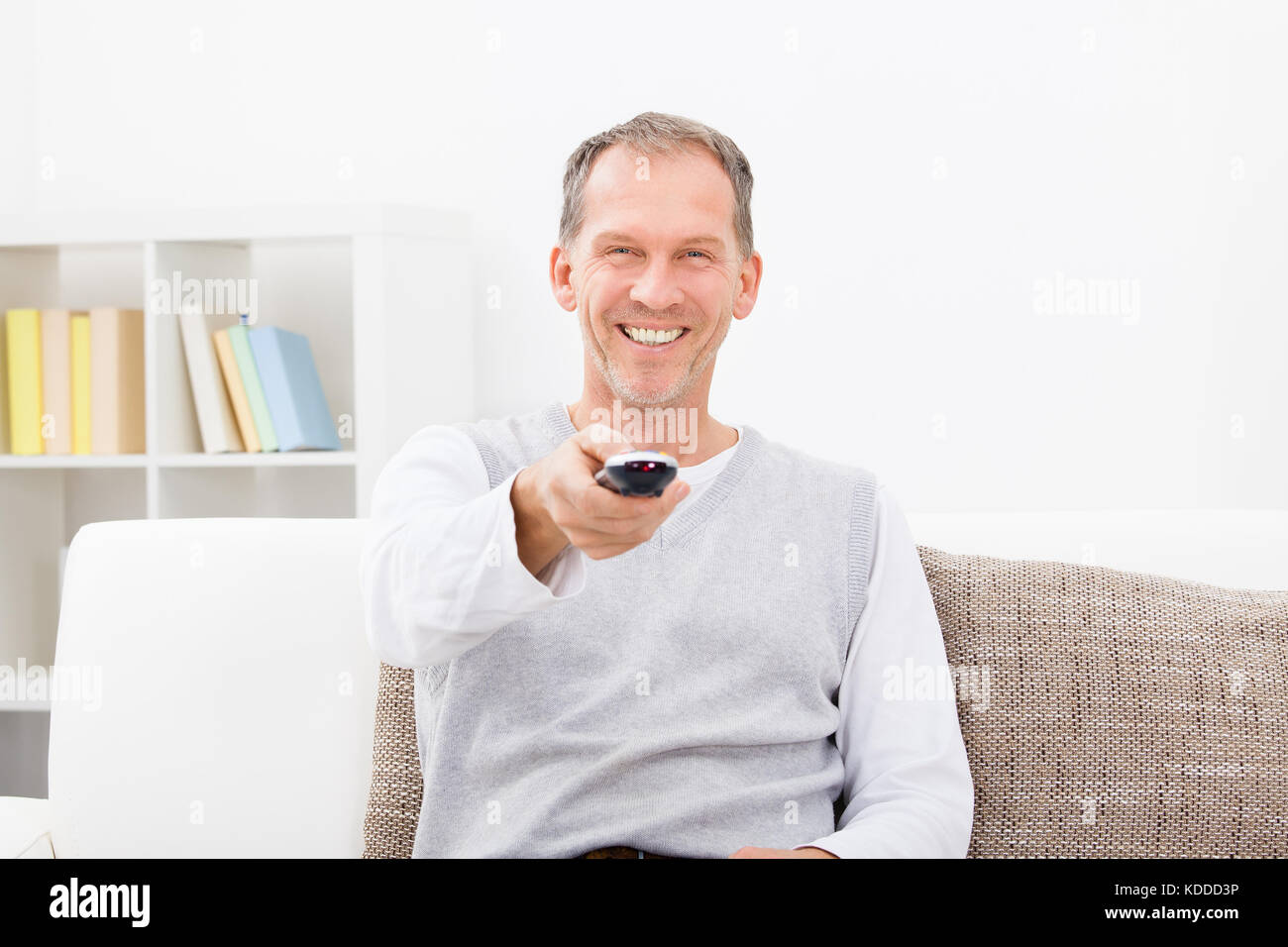 Happy Mature Man Changing Television Channel Using Remote Stock Photo ...