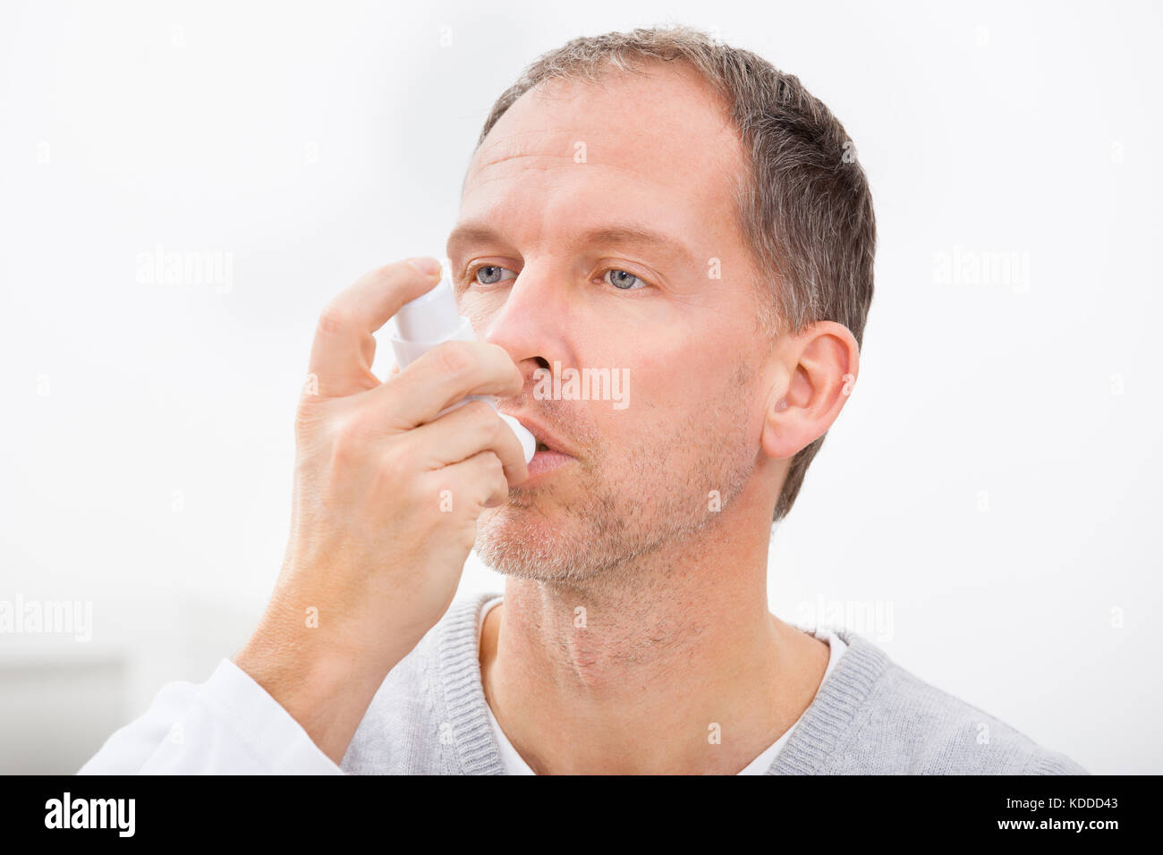 Man With Asthma Using An Asthma Inhaler For Preventing Attacks Stock ...