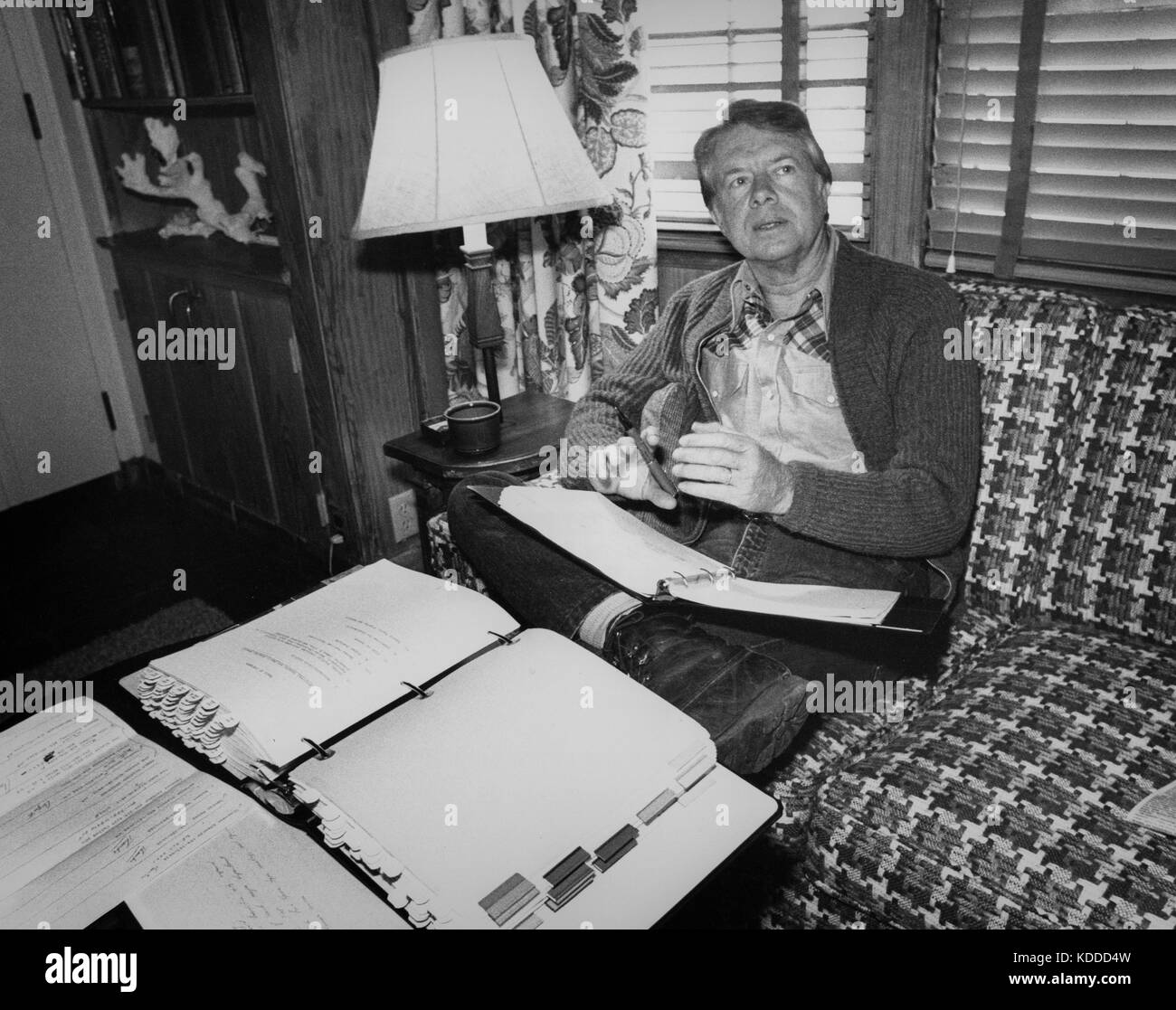 President Jimmy Carter works through briefing books while on vacation ...
