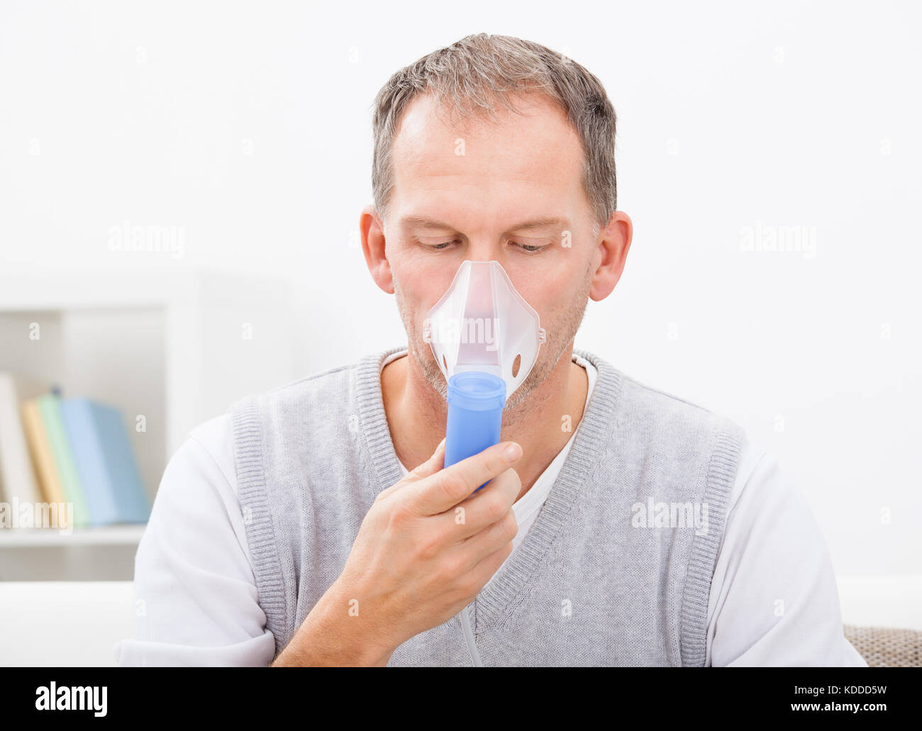 Man Doing Inhalation Through Oxygen Mask At Home Stock Photo - Alamy