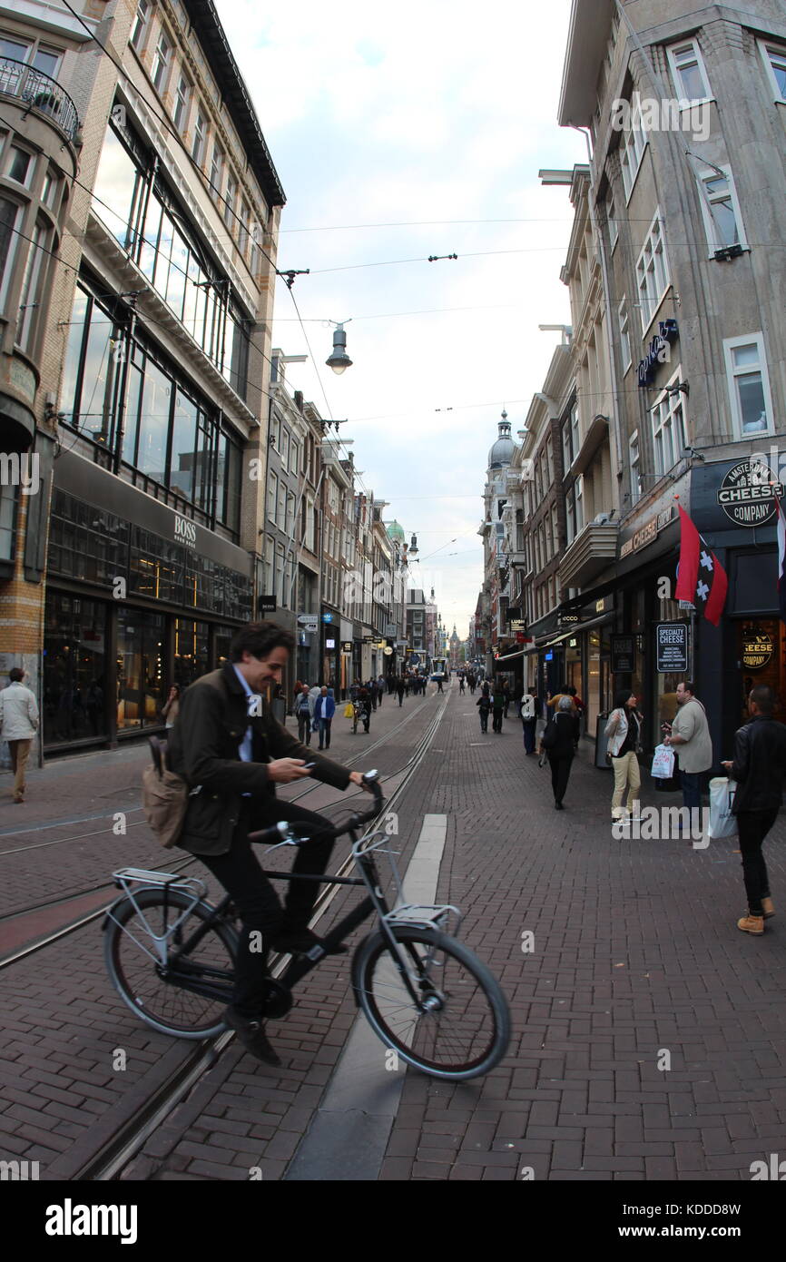 Man crossing the street on his bicycle in Amsterdam Stock Photo - Alamy