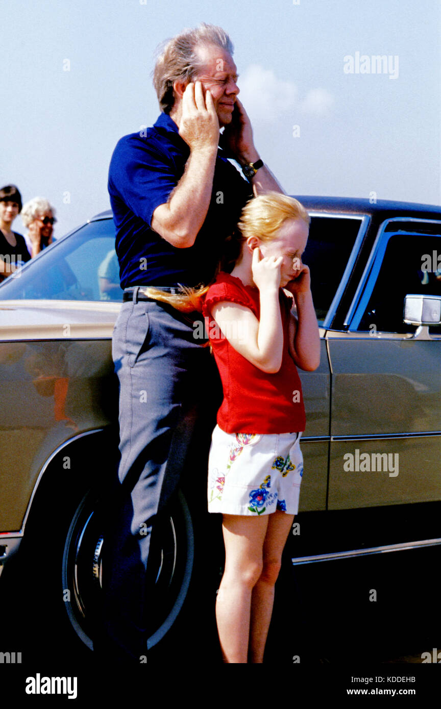 President Jimmy Carter and daughter Amy protect their ears from the ...