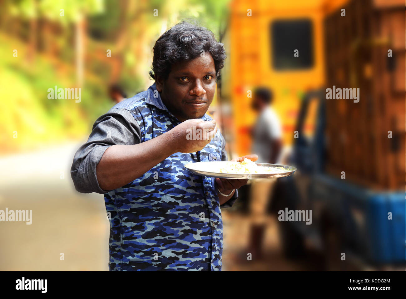Young man eating food on outdoor Stock Photo - Alamy