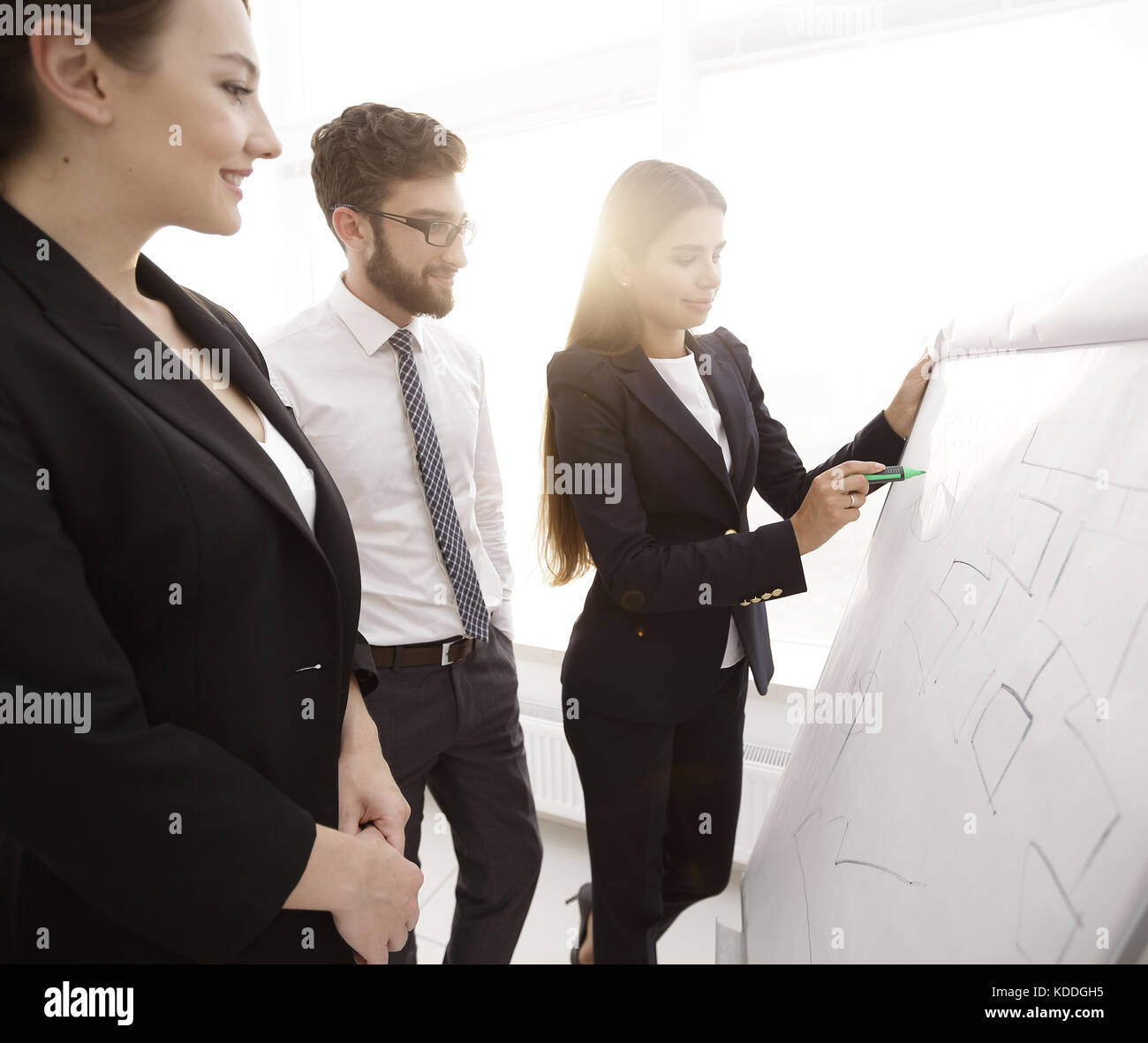 businesswoman pointing marker to flipboard on presentation in office ...