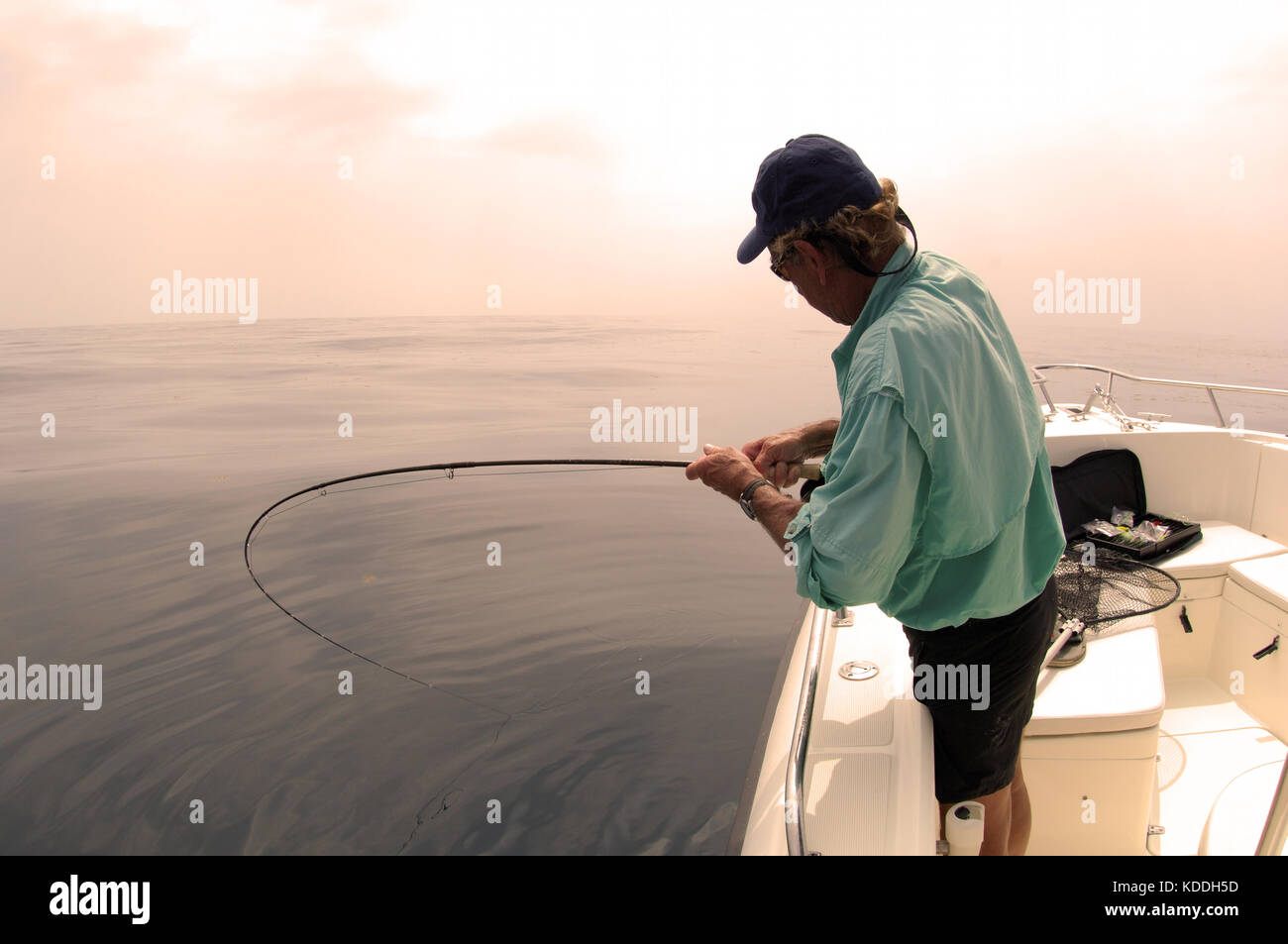 A fly fisherman fights a big fish while fishing offshore from Freeport ...