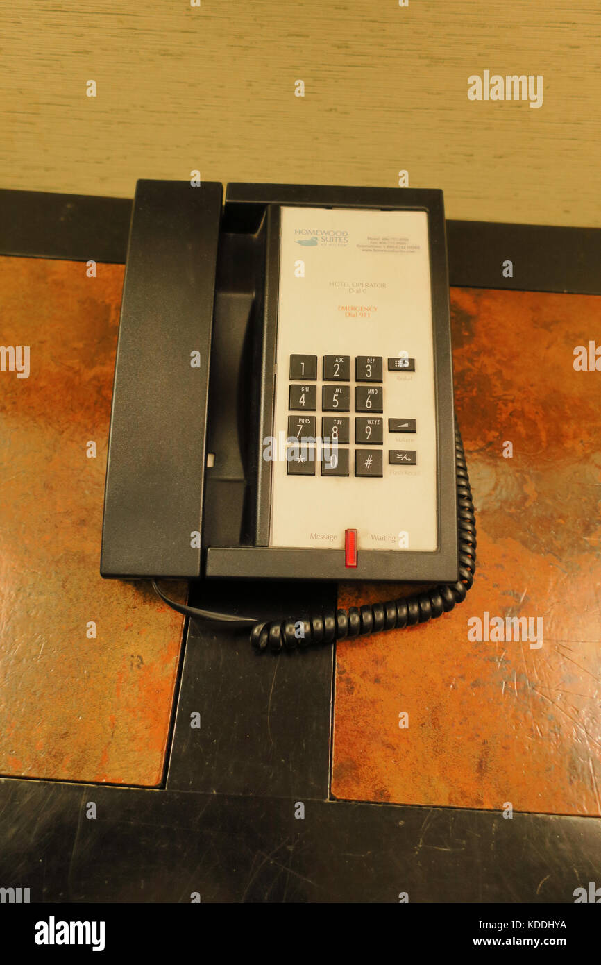 A hotel phone a table Stock Photo - Alamy