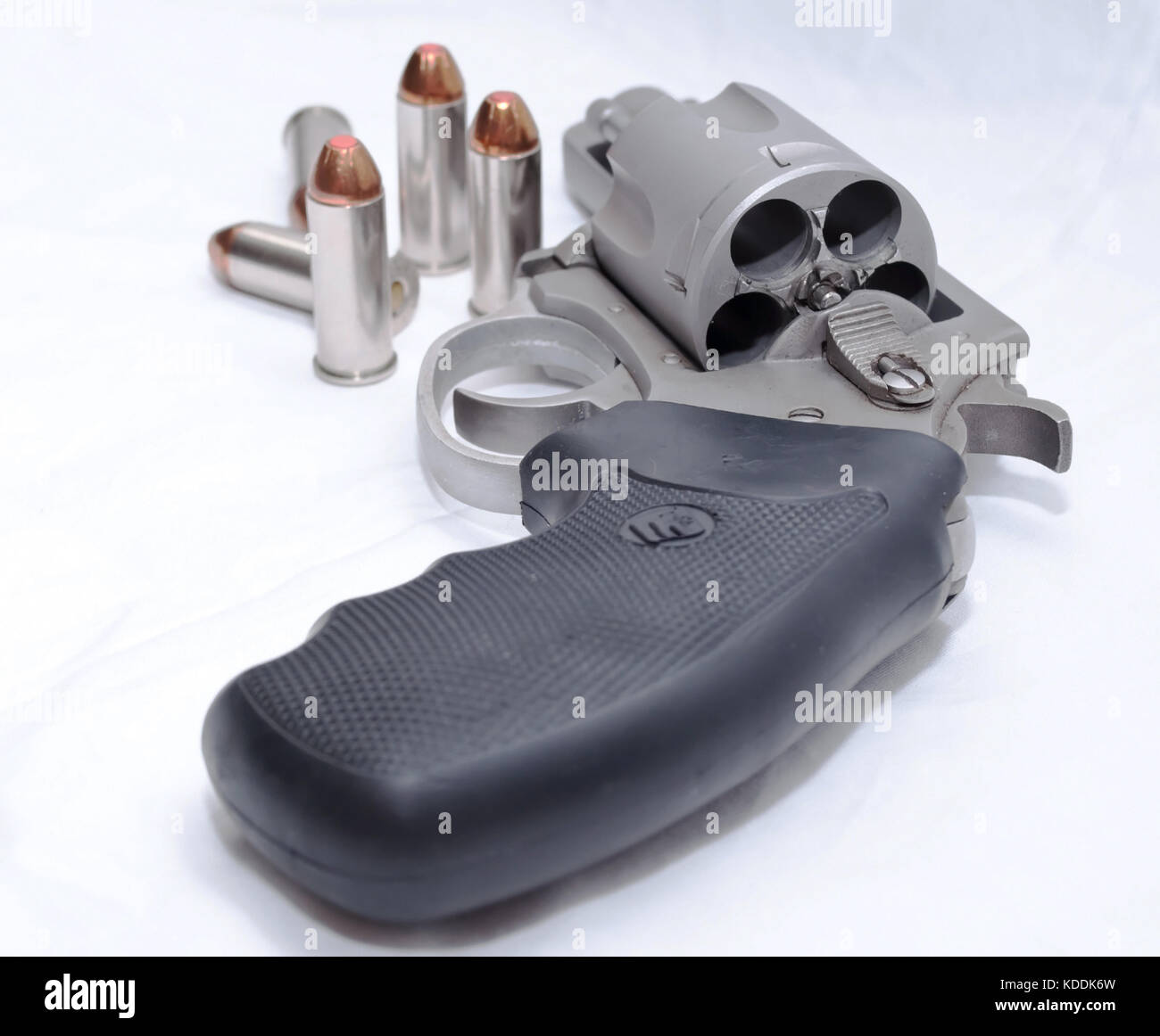 An unloaded 44spl revolver with the cylinder opened and it's bullets ...